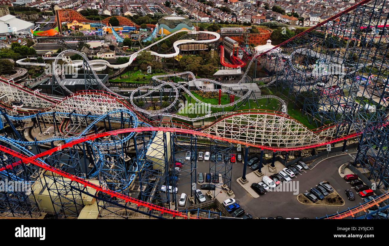 An aerial view of a vibrant amusement park featuring multiple roller ...