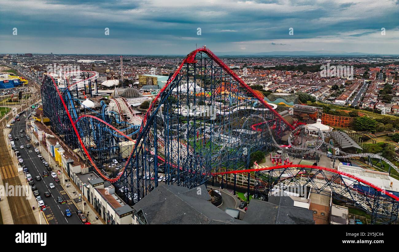 Aerial view of a vibrant amusement park featuring a large roller ...
