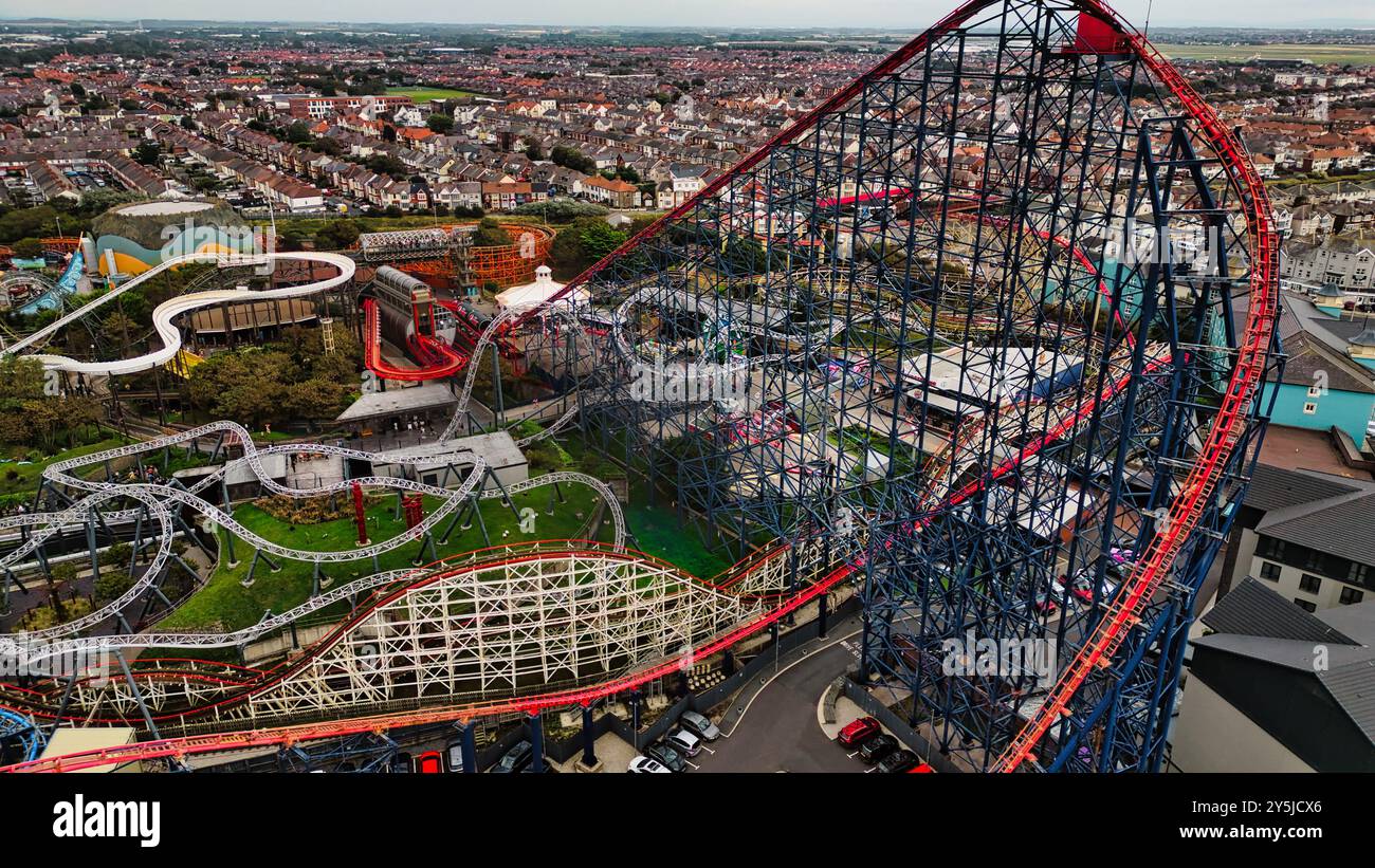An aerial view of a vibrant amusement park featuring multiple roller ...