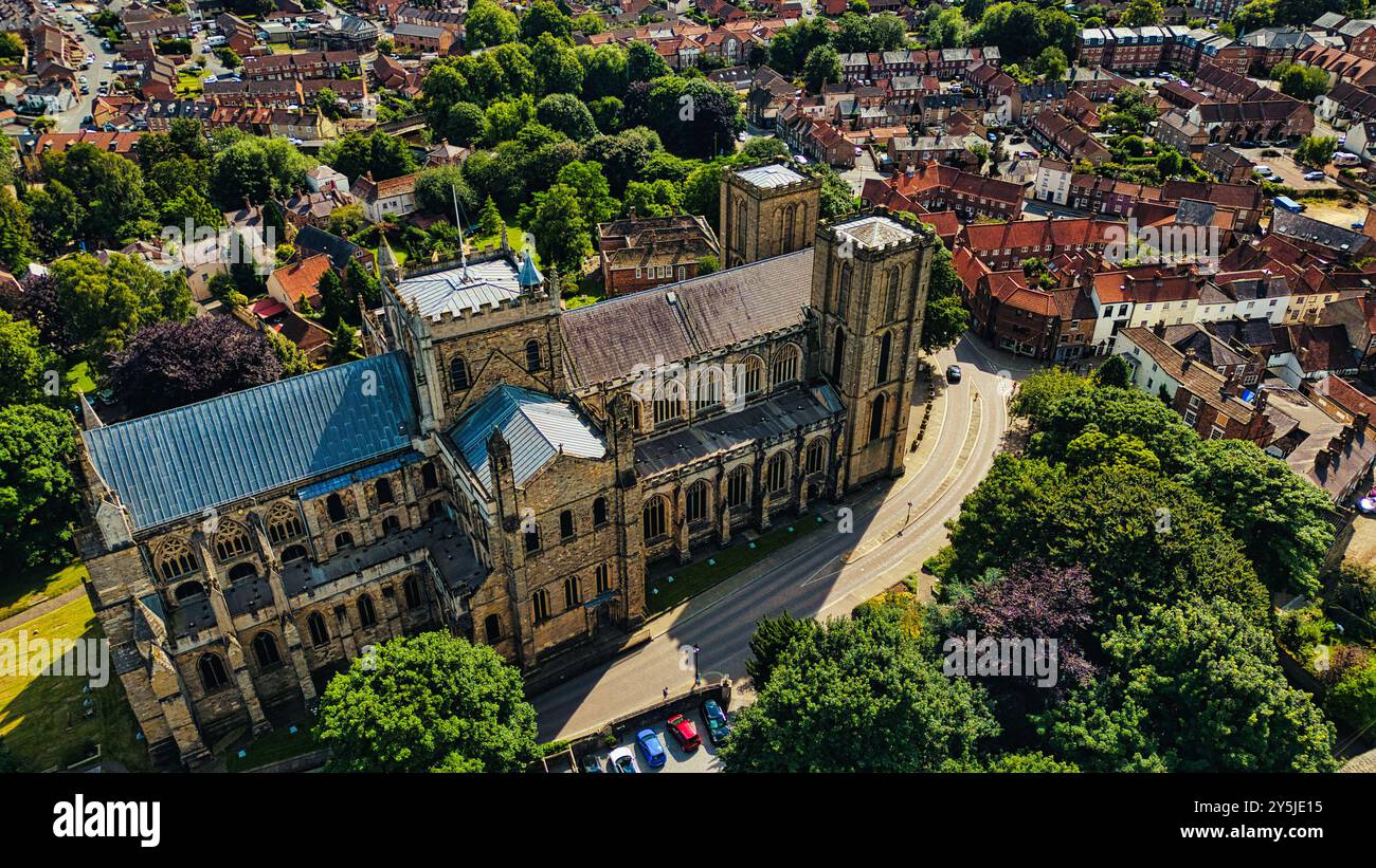 Aerial view of a large cathedral surrounded by lush greenery and ...