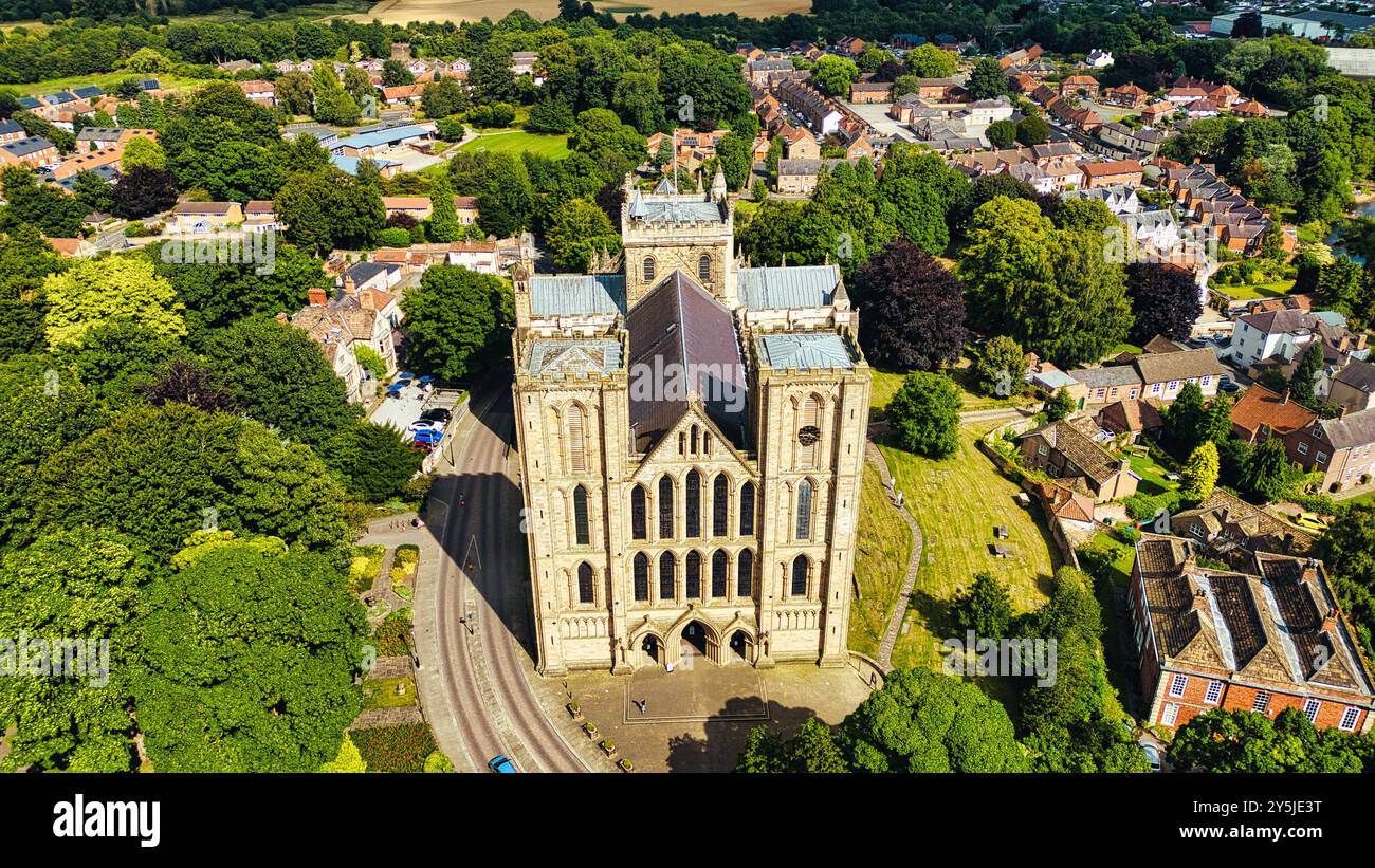 Aerial view of a large historic cathedral surrounded by lush greenery ...