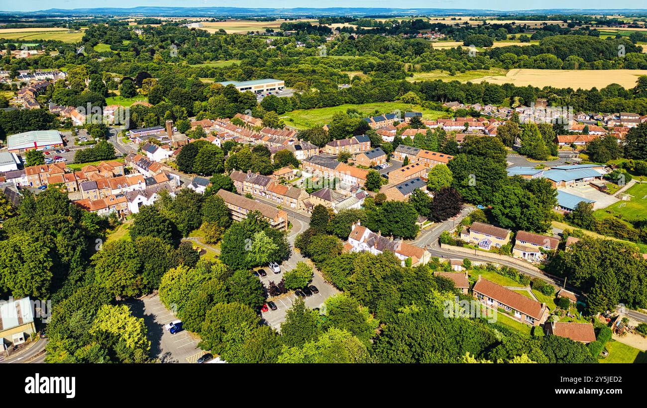 Aerial view of a picturesque village surrounded by lush greenery and ...