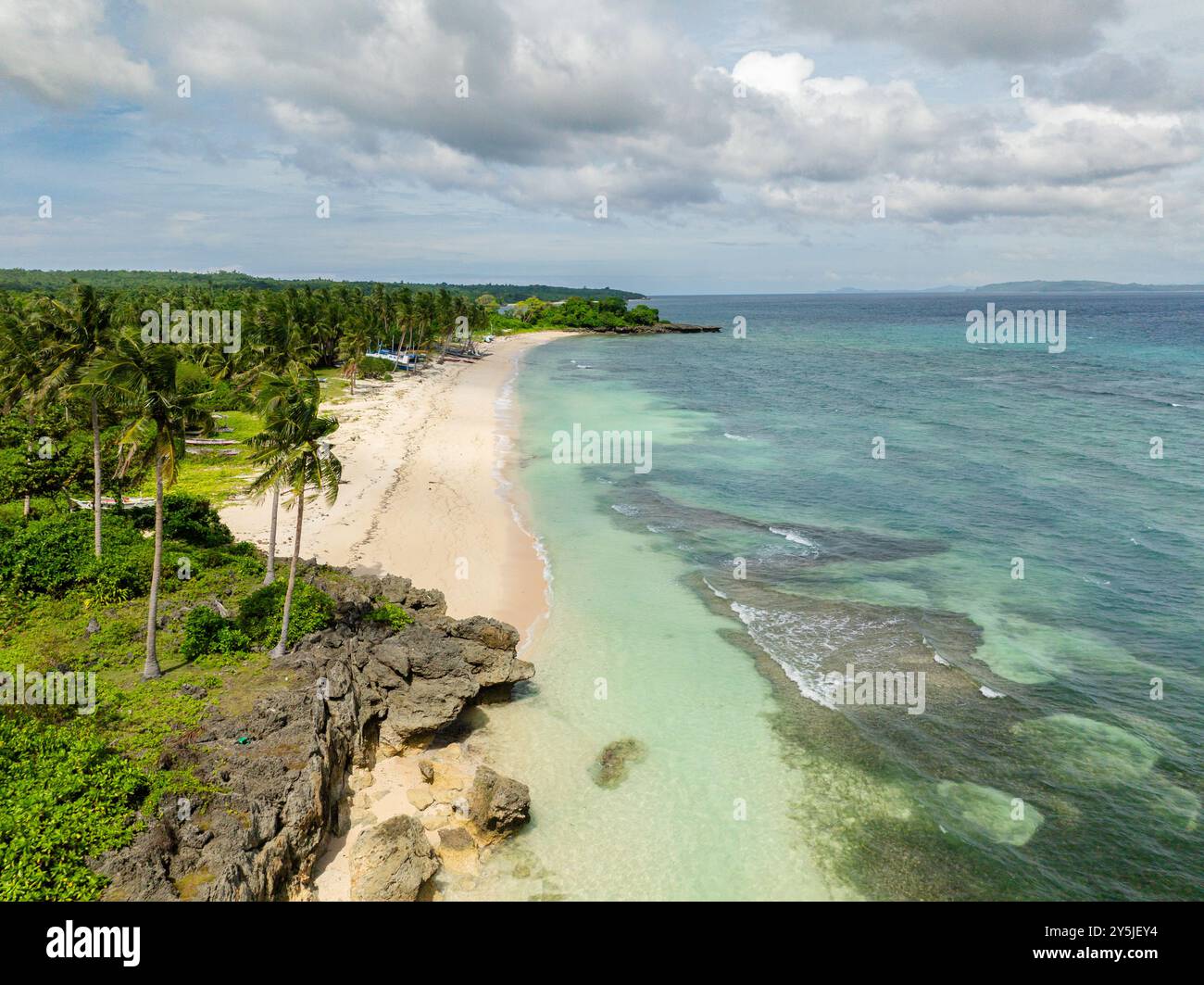 White beach view through palm trees in Carabao Island. Romblon ...