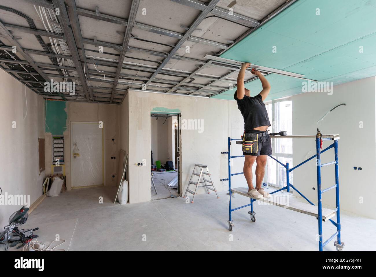 Drywall Installers. Men holding a gypsum board figured cut Stock Photo ...