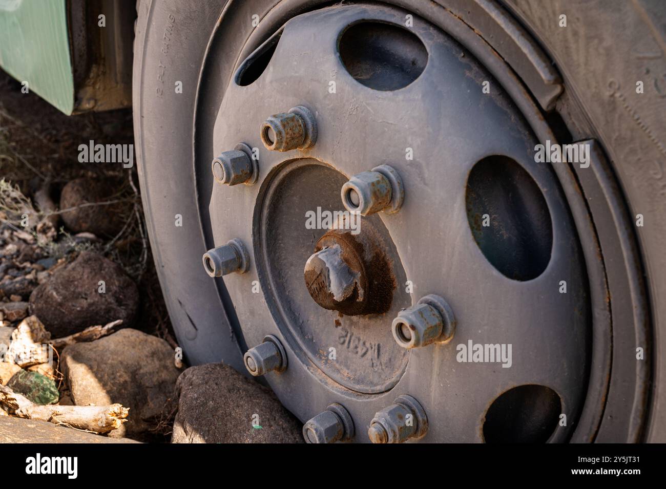 A tire with a black rim and a white number on it. The tire is old and ...