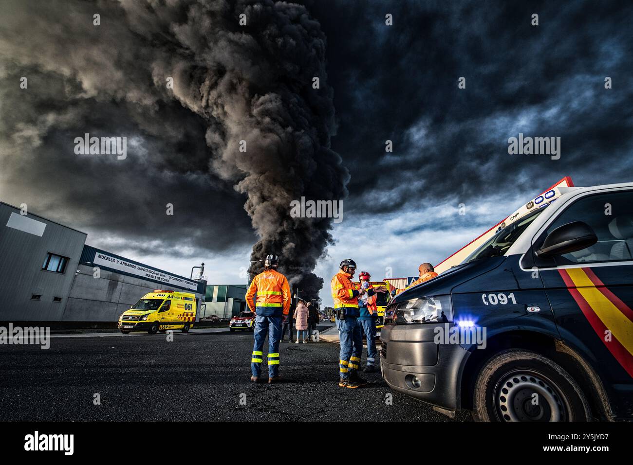 A big column of smoke rises for a fire in an industrial estate Stock ...