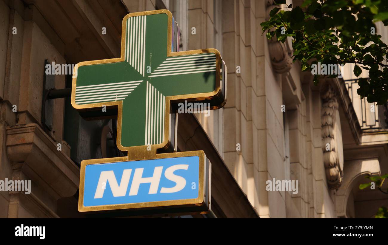 NHS signage outside a chemist pharmacy on Great Portland Street, London ...
