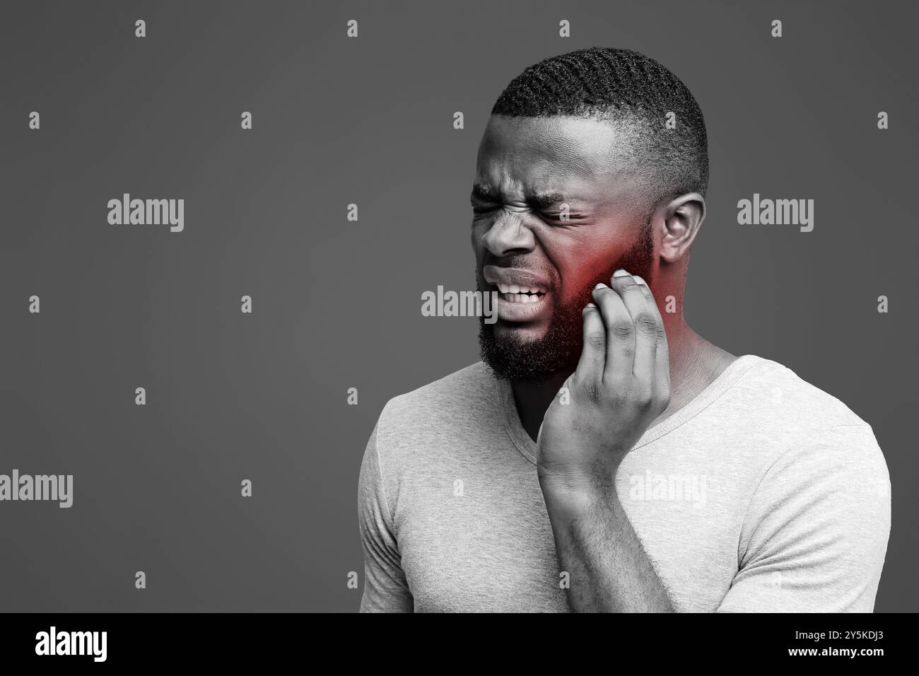 Young afro man having wisdom teeth problem Stock Photo - Alamy