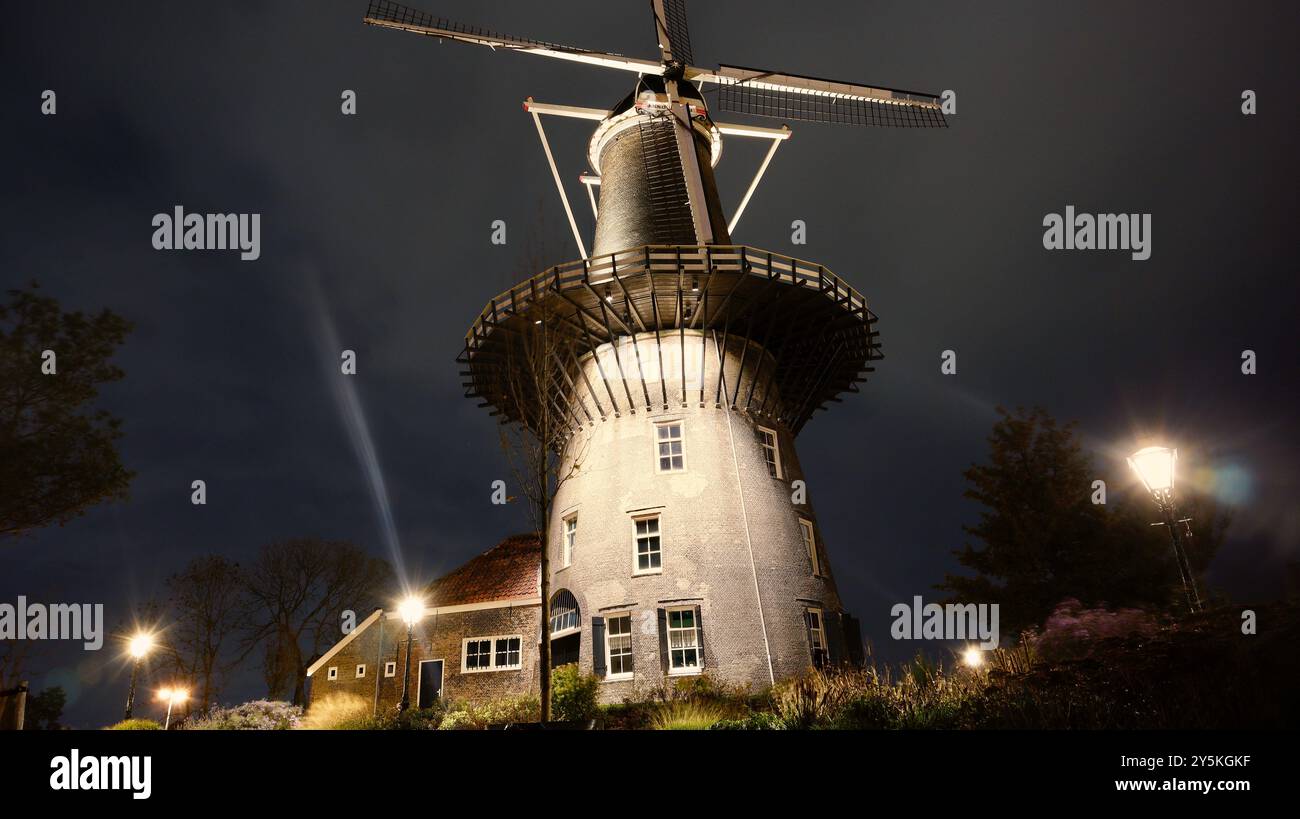 The Illuminated Molen De Valk windmill at night with a dark sky ...