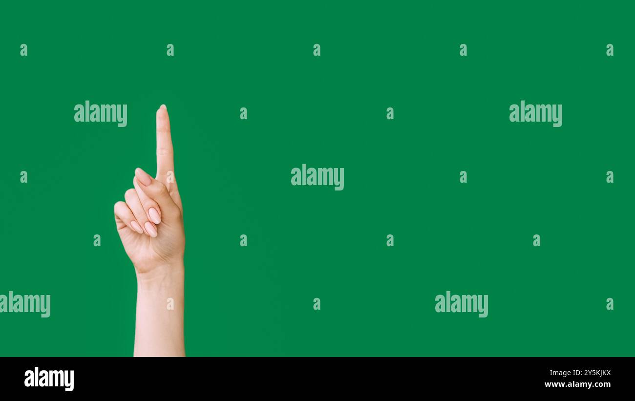 Pointing up. Idea gesture. Look here. Female hand index finger showing ...