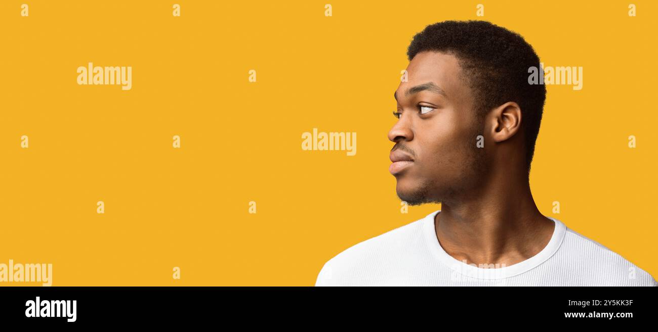 Side portrait of masculine afro guy looking at copyspace Stock Photo ...