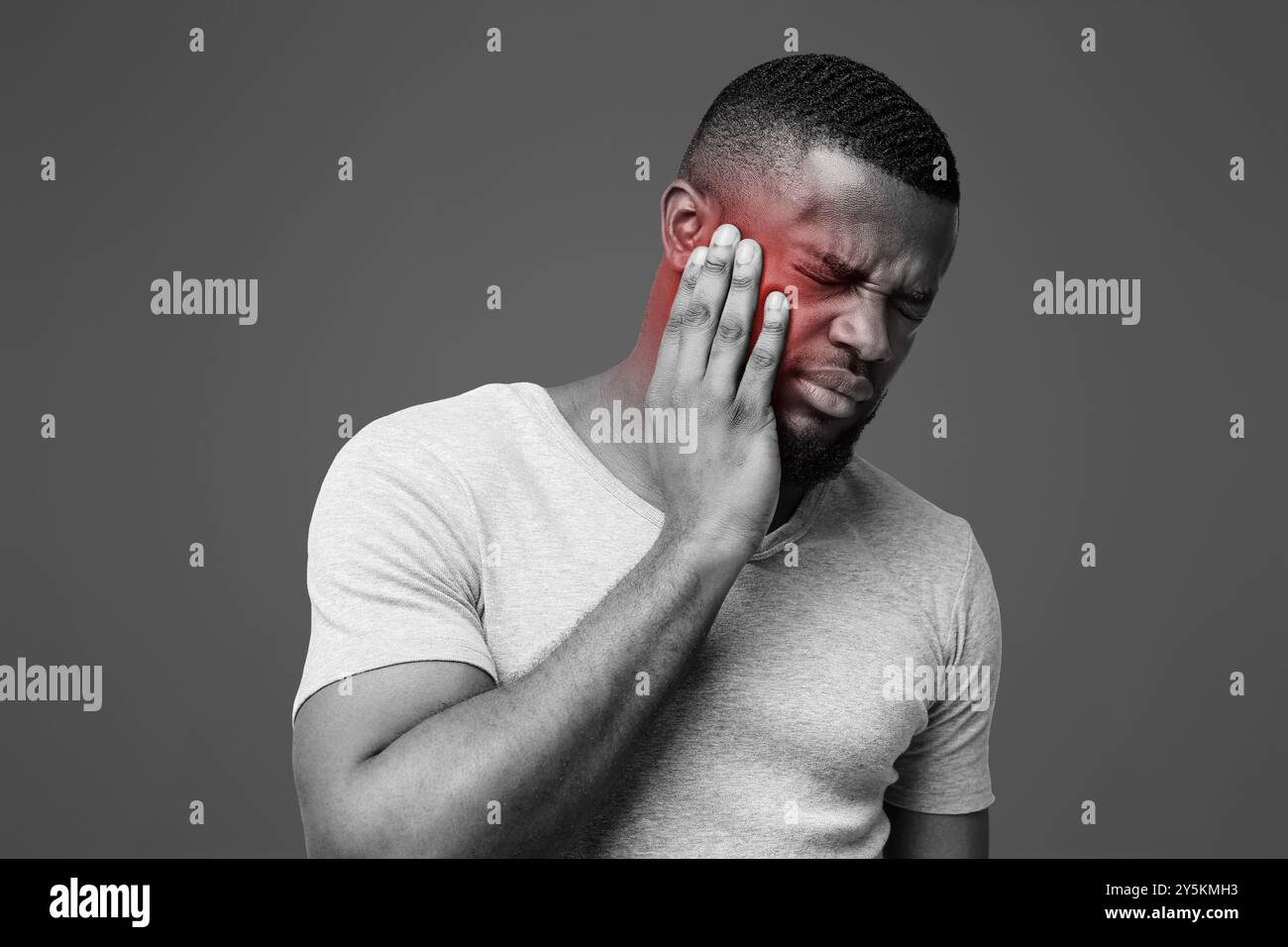 Young black guy having impacted tooth problem Stock Photo - Alamy