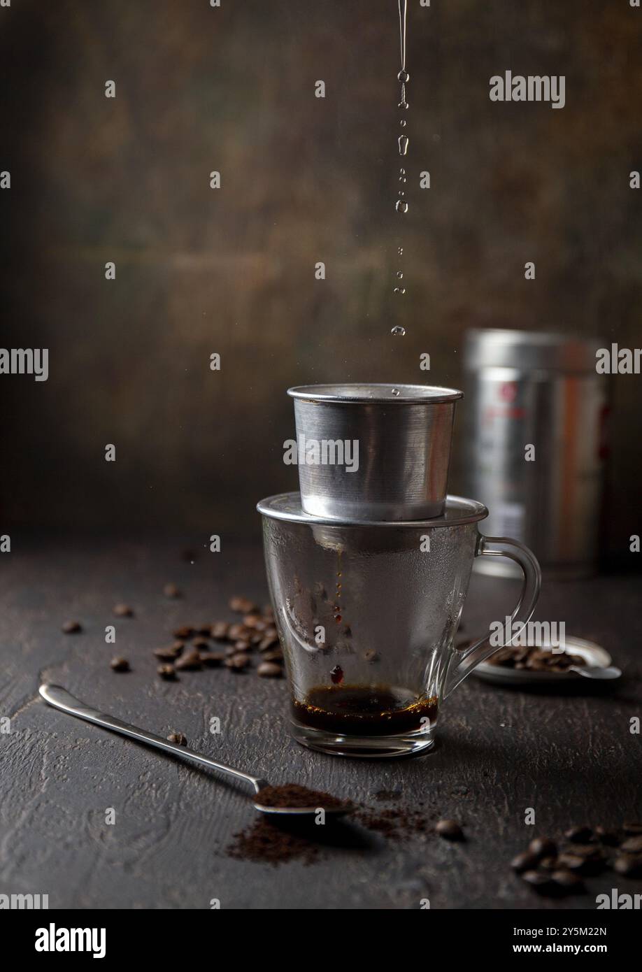 Preparation of Vietnamese coffe with aluminum cofe filer on dark ...