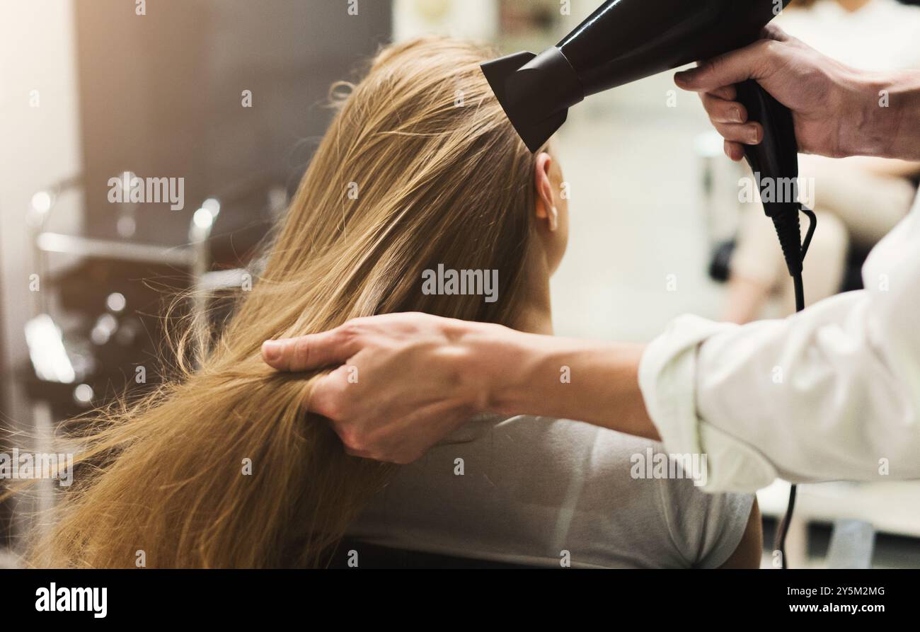 Making hairstyle using hair dryer Stock Photo - Alamy