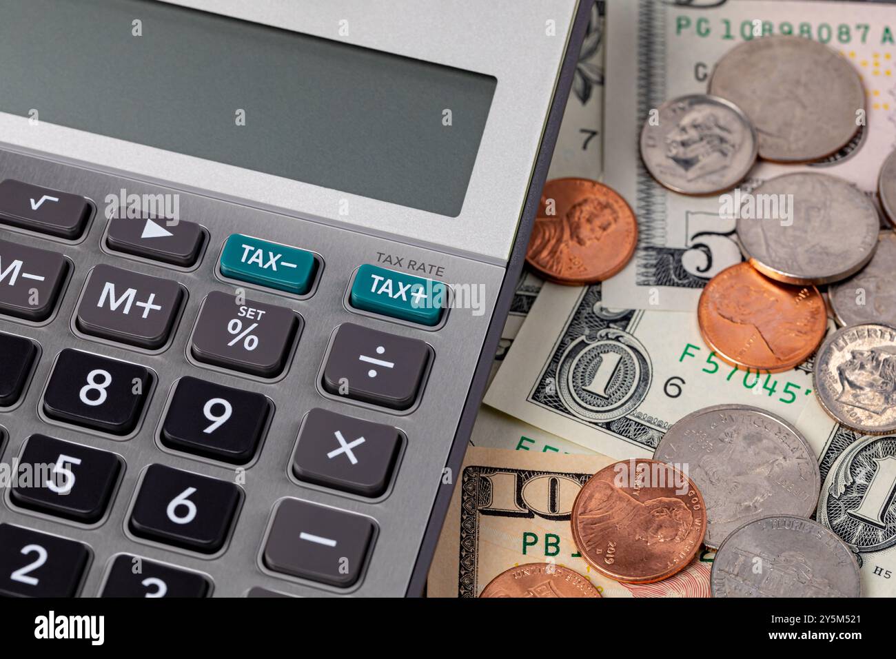 Tax rate calculator with cash money and coins. Income, sales tax and ...