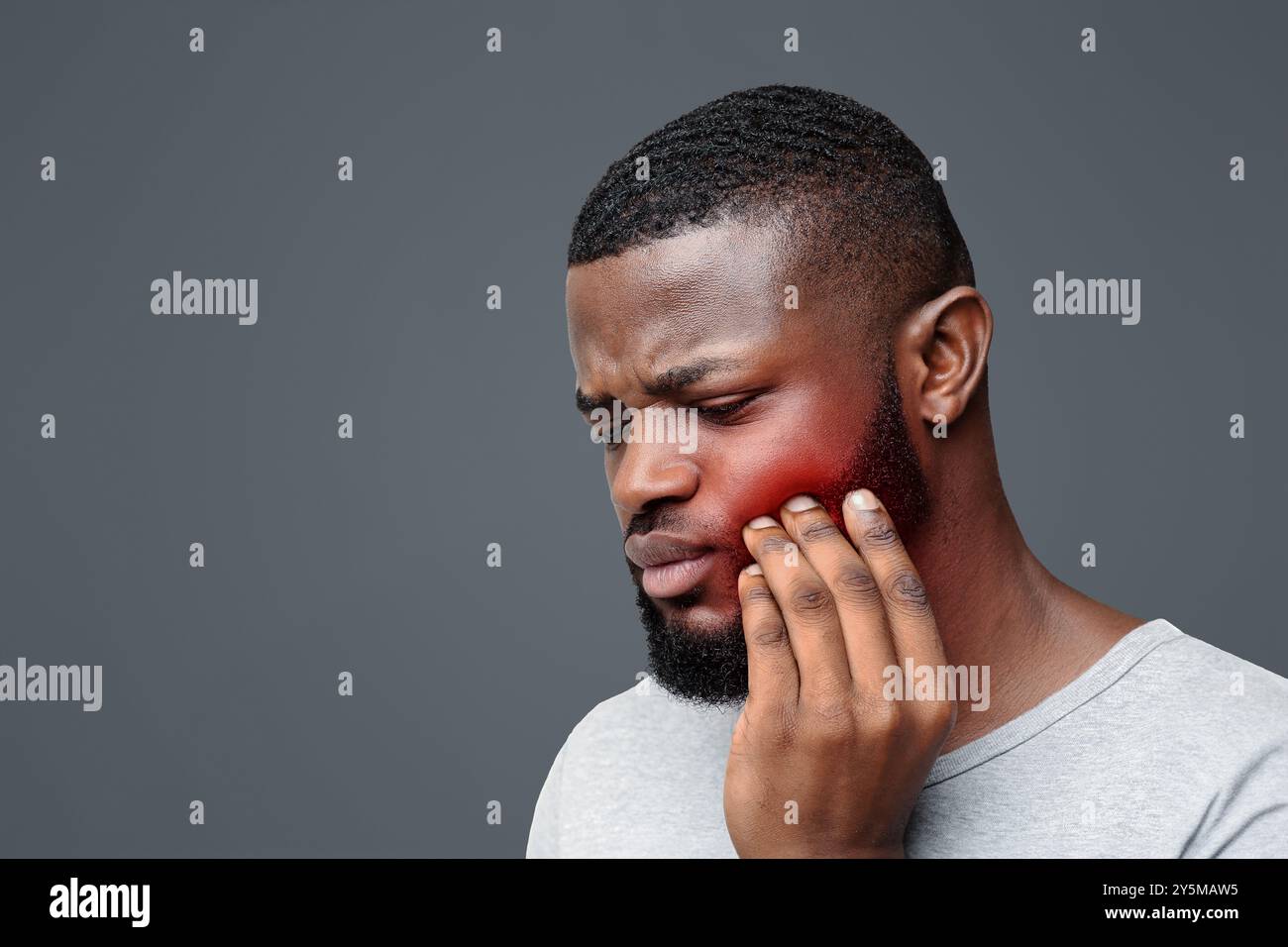 Young sad man having pain in his teeth Stock Photo - Alamy