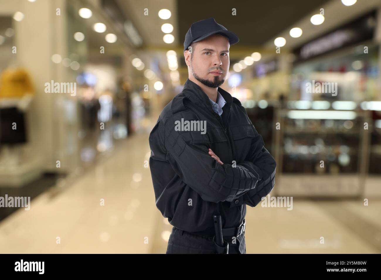 Portrait of confident security guard in shopping mall Stock Photo - Alamy