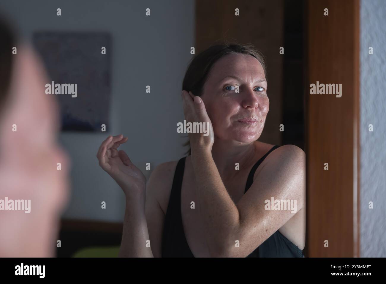 Woman applying sun lotion on face at home, selective focus Stock Photo ...