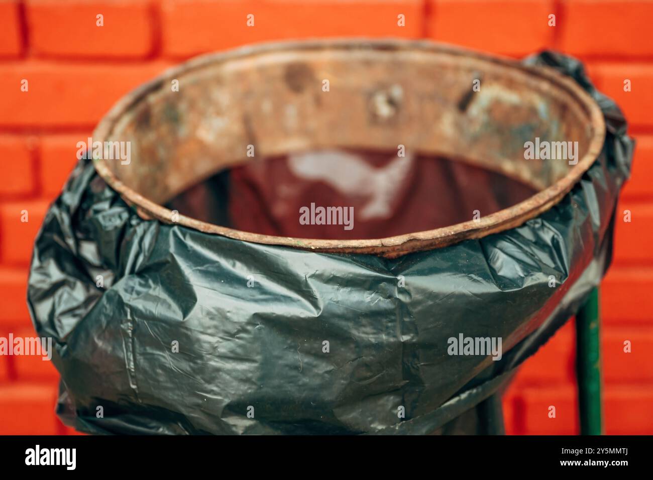 Old trash can with plastic bag, selective focus Stock Photo - Alamy