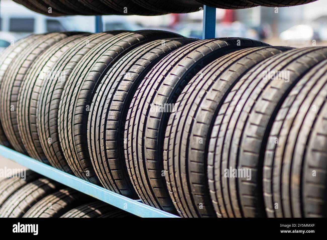 There is a stack of tires that are neatly arranged and placed on a ...