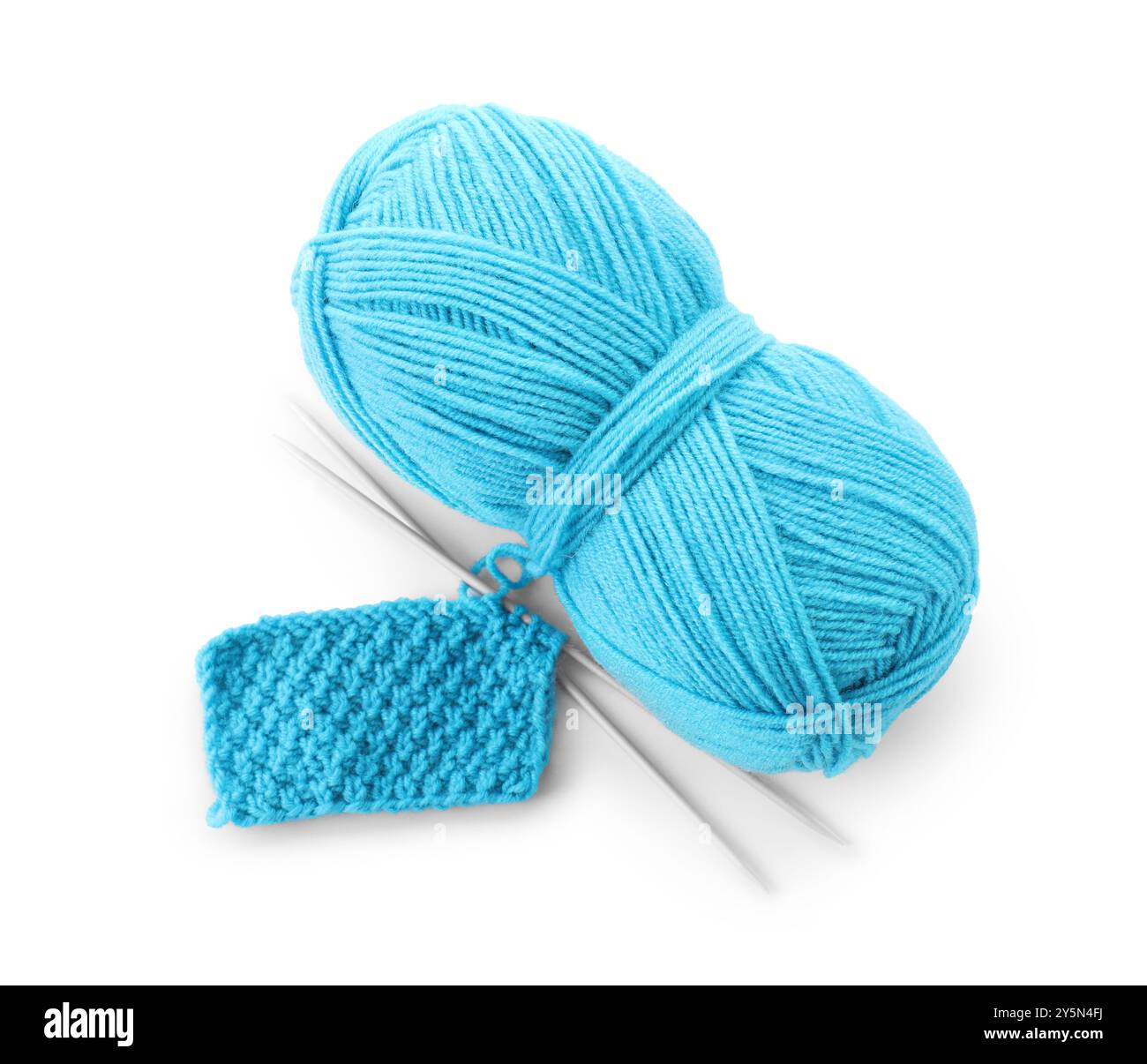Skein of light blue yarn, knitted fabric and needles isolated on white ...