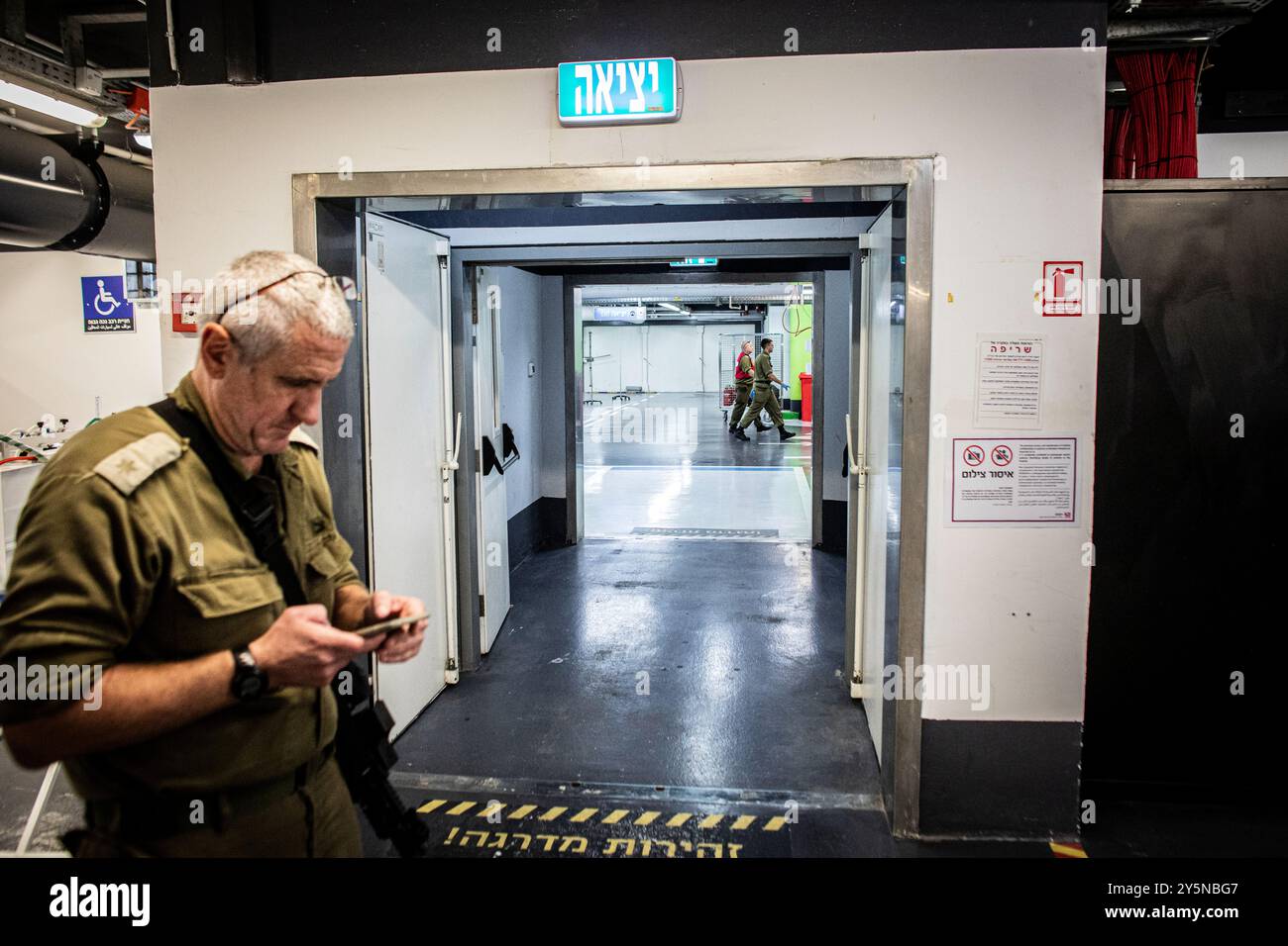 An Israeli soldier stands next to the blast doors at the underground ...