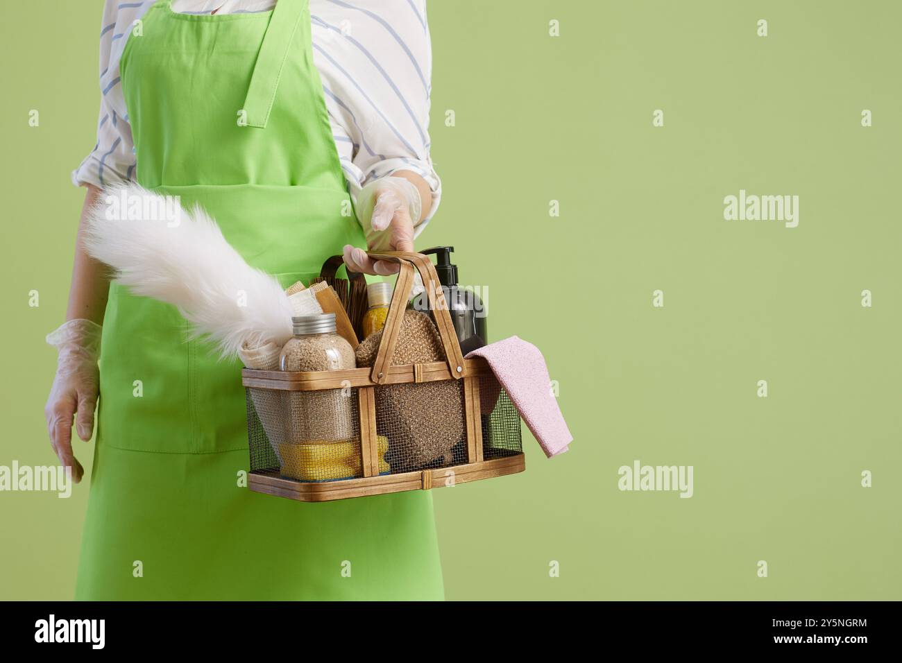 Spring cleaning. Closeup on modern housewife in green apron and rubber ...