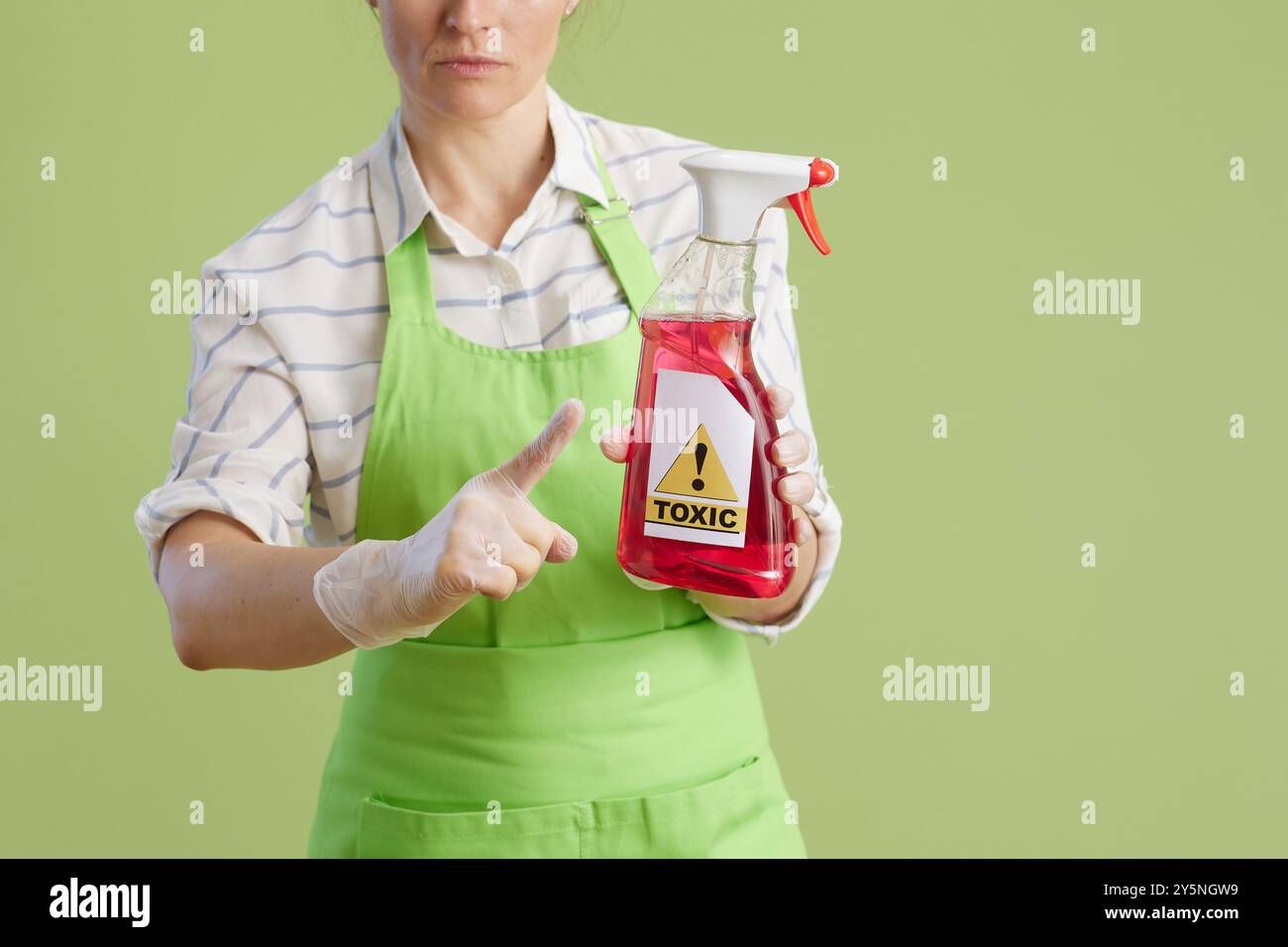 Spring cleaning. Closeup on concerned modern woman in green apron and ...