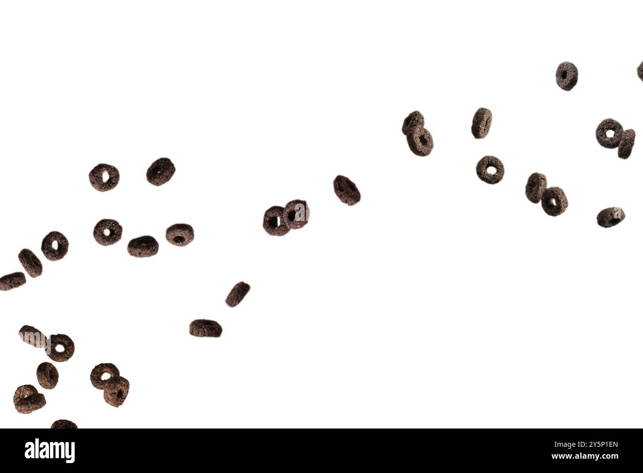 Chocolate rings cereal spill out into a bowl. Breakfast. Isolated on a ...