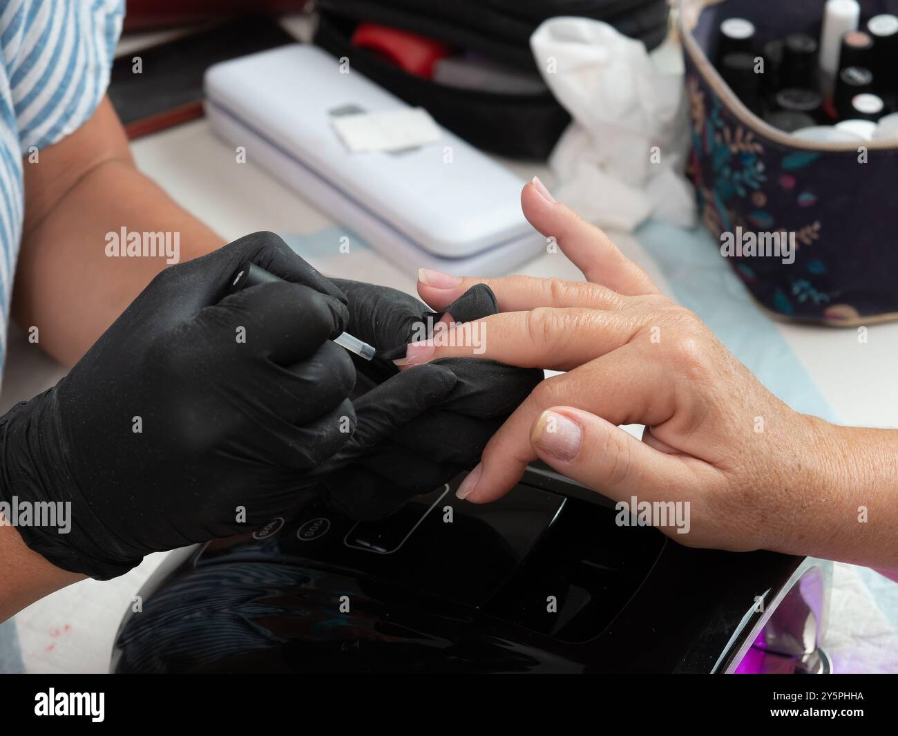 Professional manicurist applying cuticle hi-res stock photography and ...