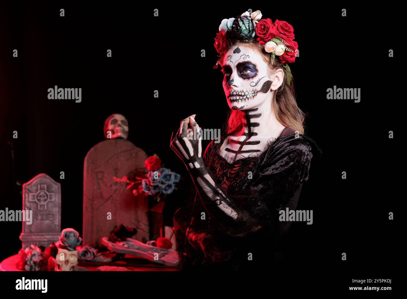 Woman wearing corpse makeup, horror costume and flower headband to ...
