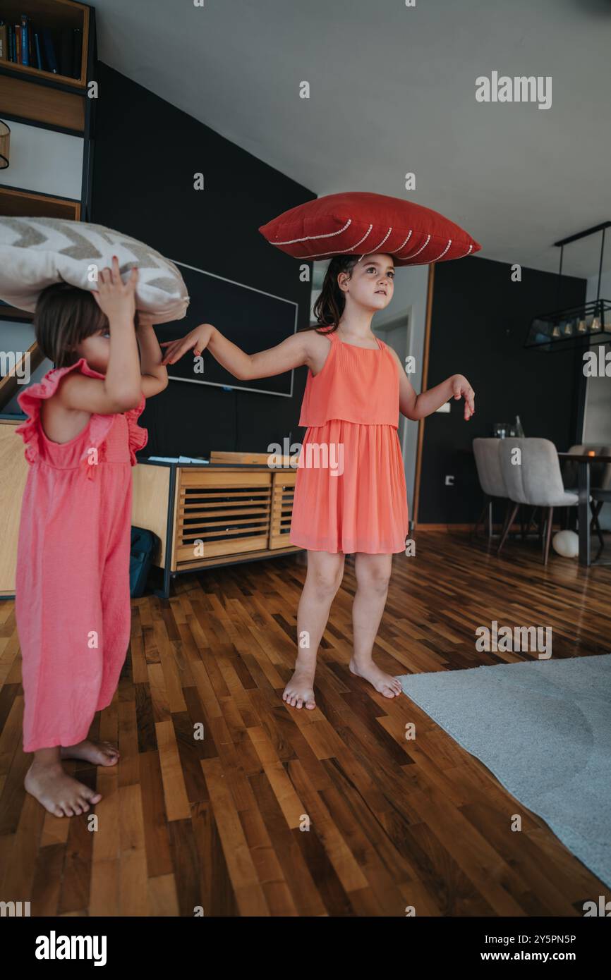 Two children balancing pillows on their heads in a playful setting ...