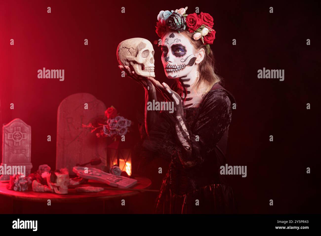Woman posing with skull in hand, doing Hamlet scene for Day of the Dead ...
