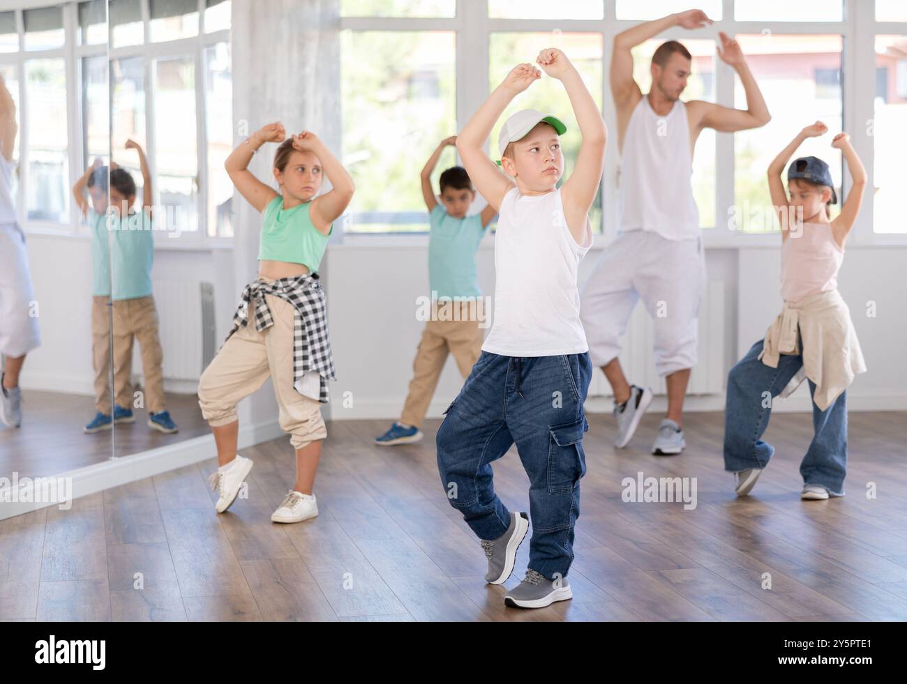 Children, together with dance teacher, practice hip-hop and ...