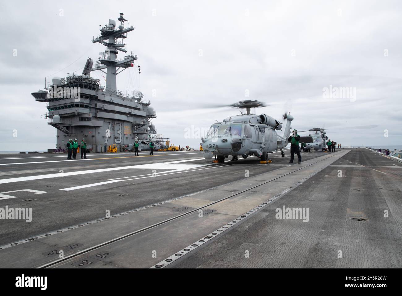 Sailors prepare to launch an MH-60 Sierra Seahawks, attached to ...