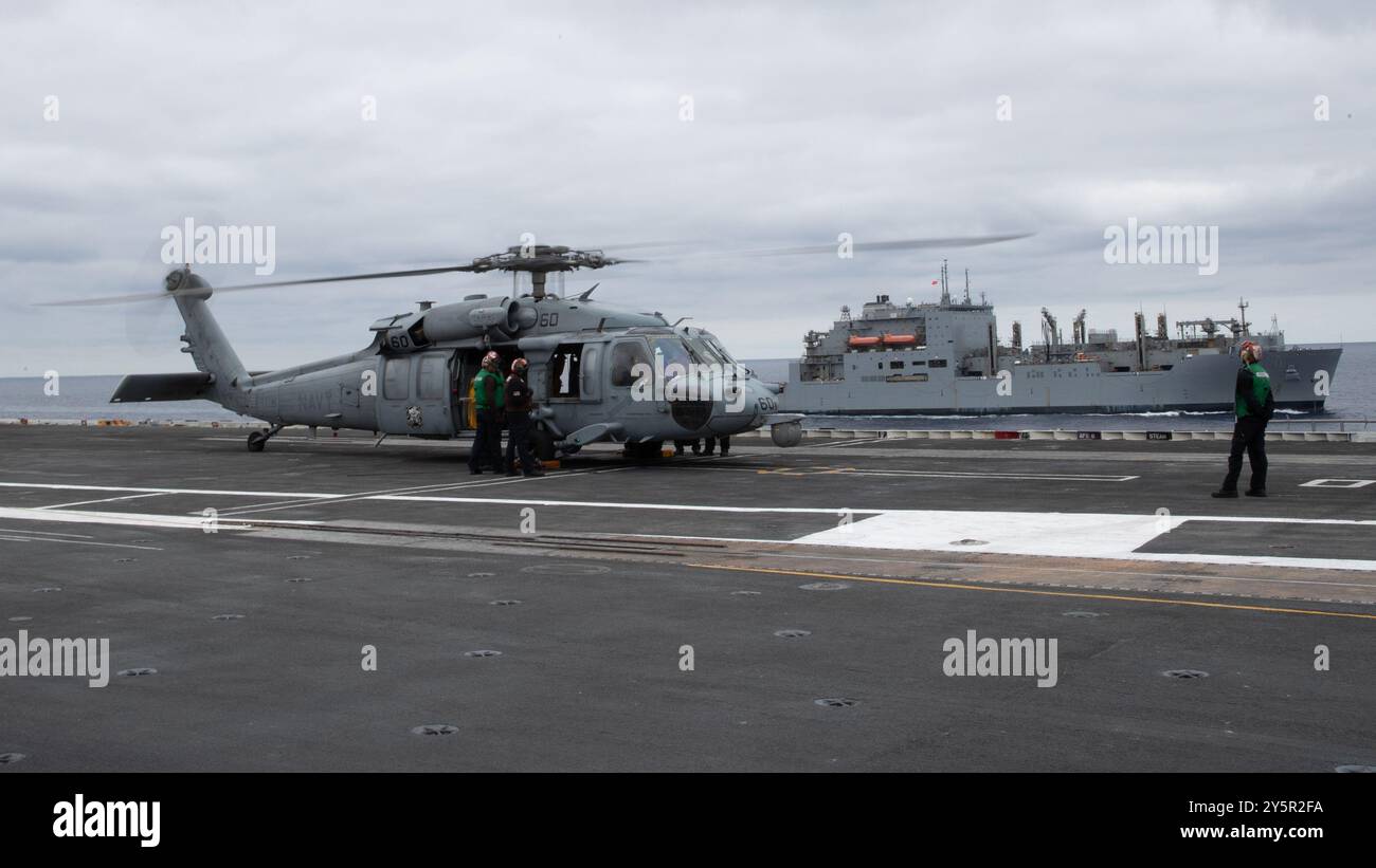 Sailors refuel an MH-60 Sierra Seahawk, attached to Helicopter Sea ...