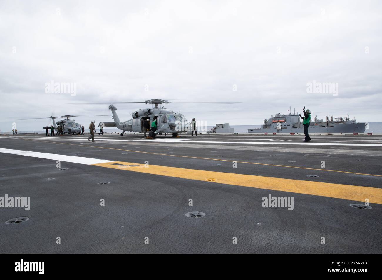 Sailors refuel an MH-60 Sierra Seahawks, attached to Helicopter Sea ...