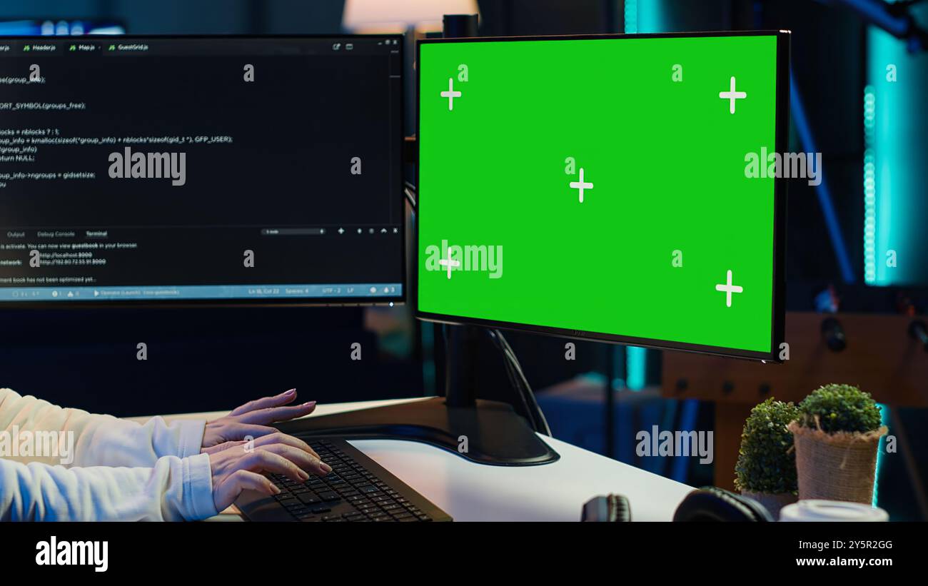 Cybersecurity expert uses green screen computer to look for security vulnerabilities and ...