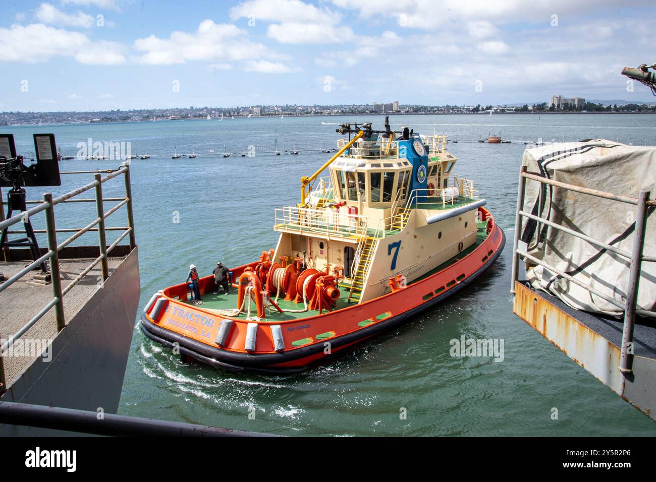 A tugboat approaches the aircraft carrier USS Nimitz (CVN 68) at Naval ...