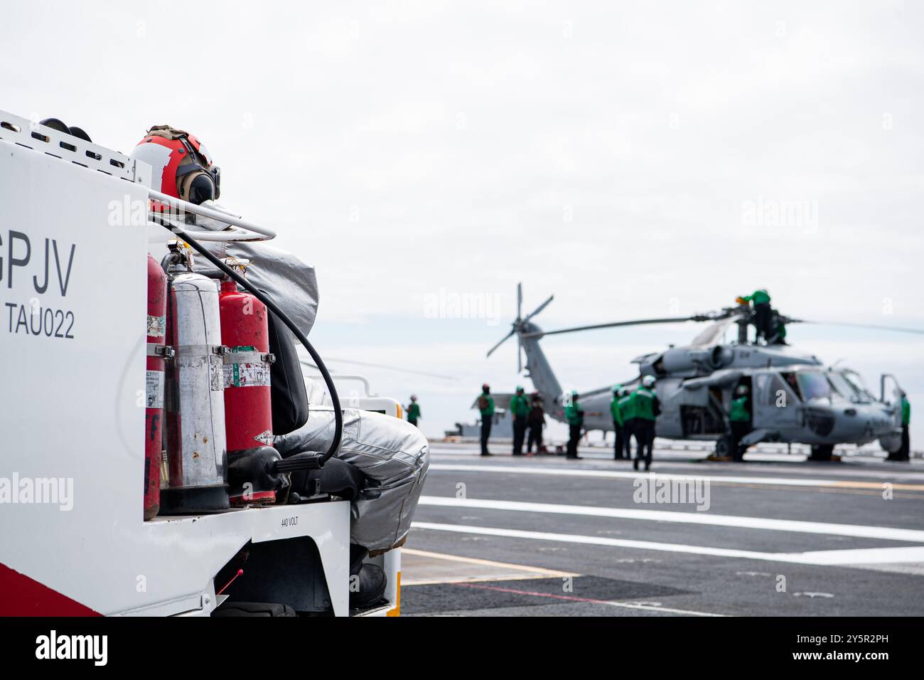 A Sailor observes flight operations on the flight deck of the aircraft ...