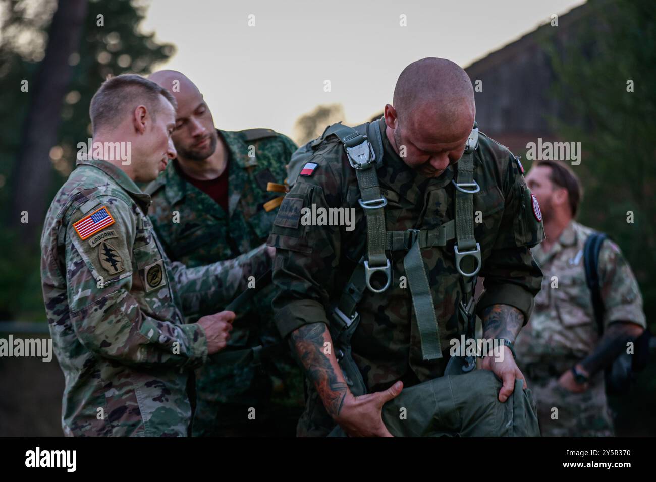 A Polish Army Soldier fits himself with U.S. parachutes and procedures ...