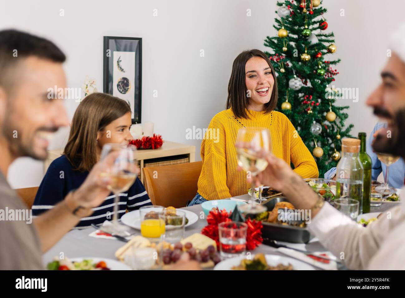 Happy family gathered around the table having christmas dinner at home ...