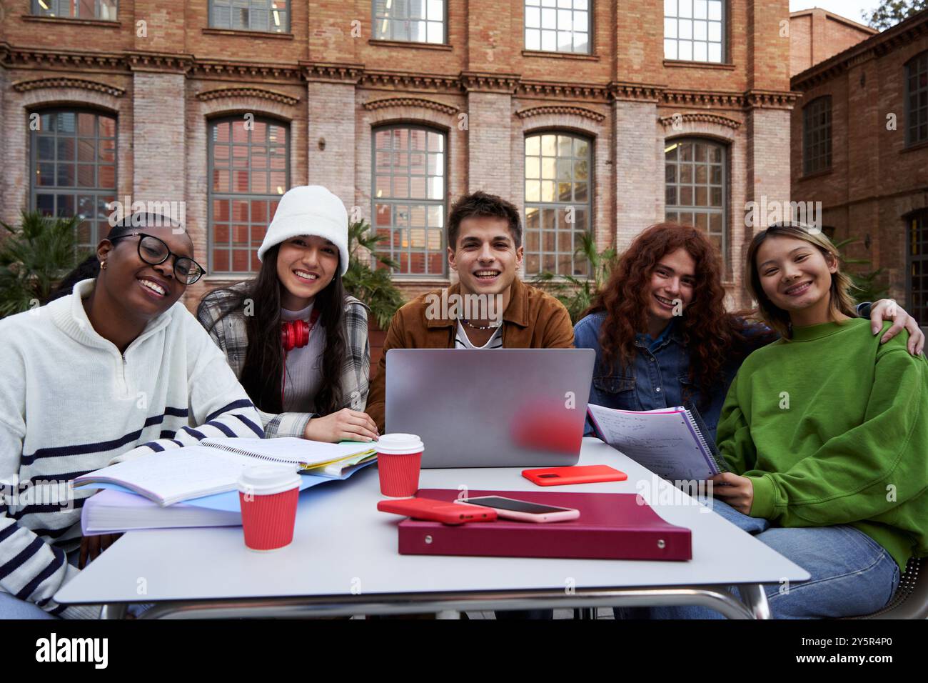 Portrait of a group of students looking at camera outside at university ...