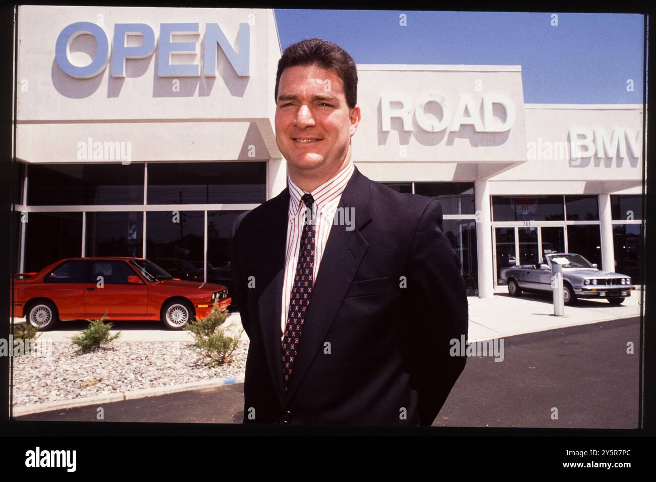 A salesman poses confidently in front of Open Road BMW in Trenton, New ... A salesman poses confidently in front of Open Road BMW in Trenton, New ...
