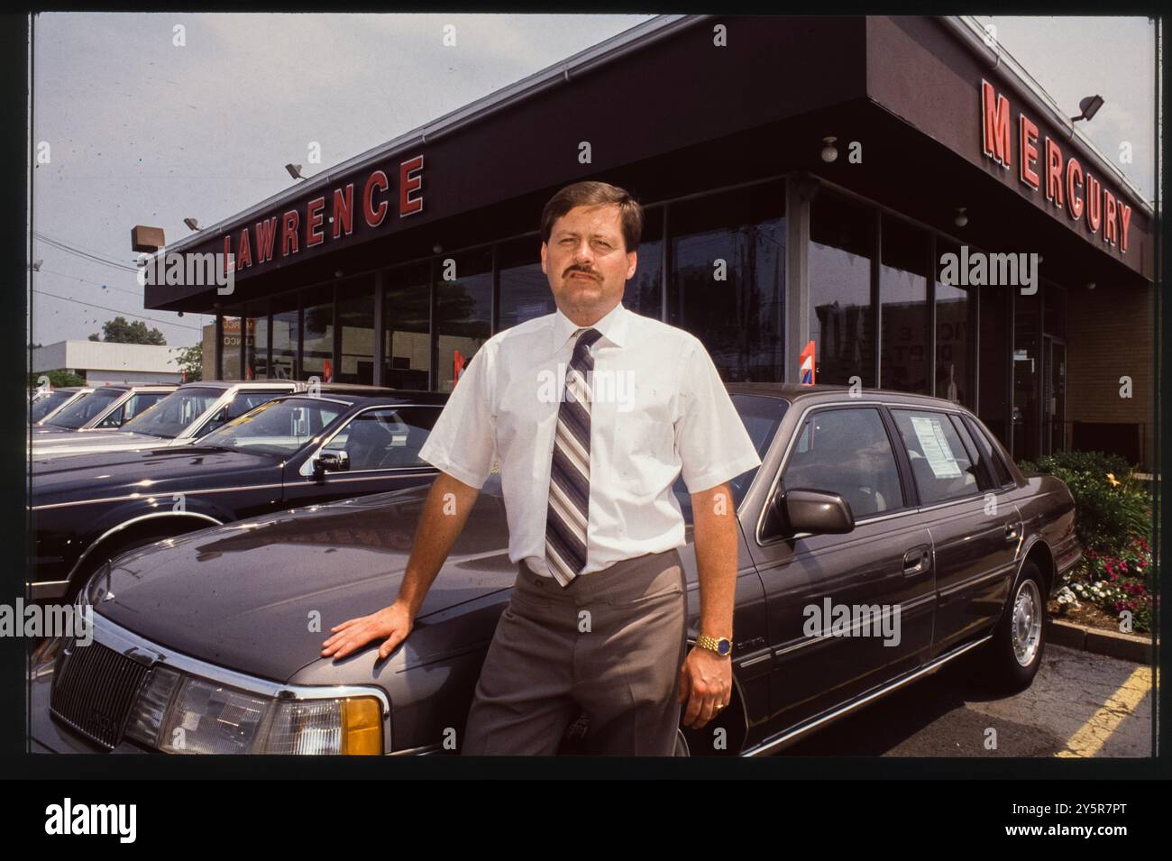 A salesman stands in front of Lawrence Mercury dealership in Trenton ...
