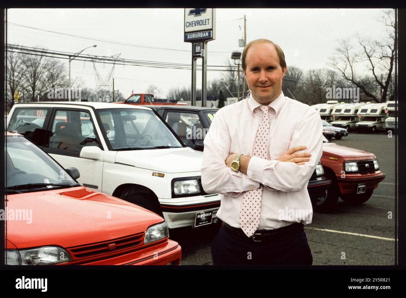 A salesman poses confidently in front of Suburban Chevrolet in Trenton ...