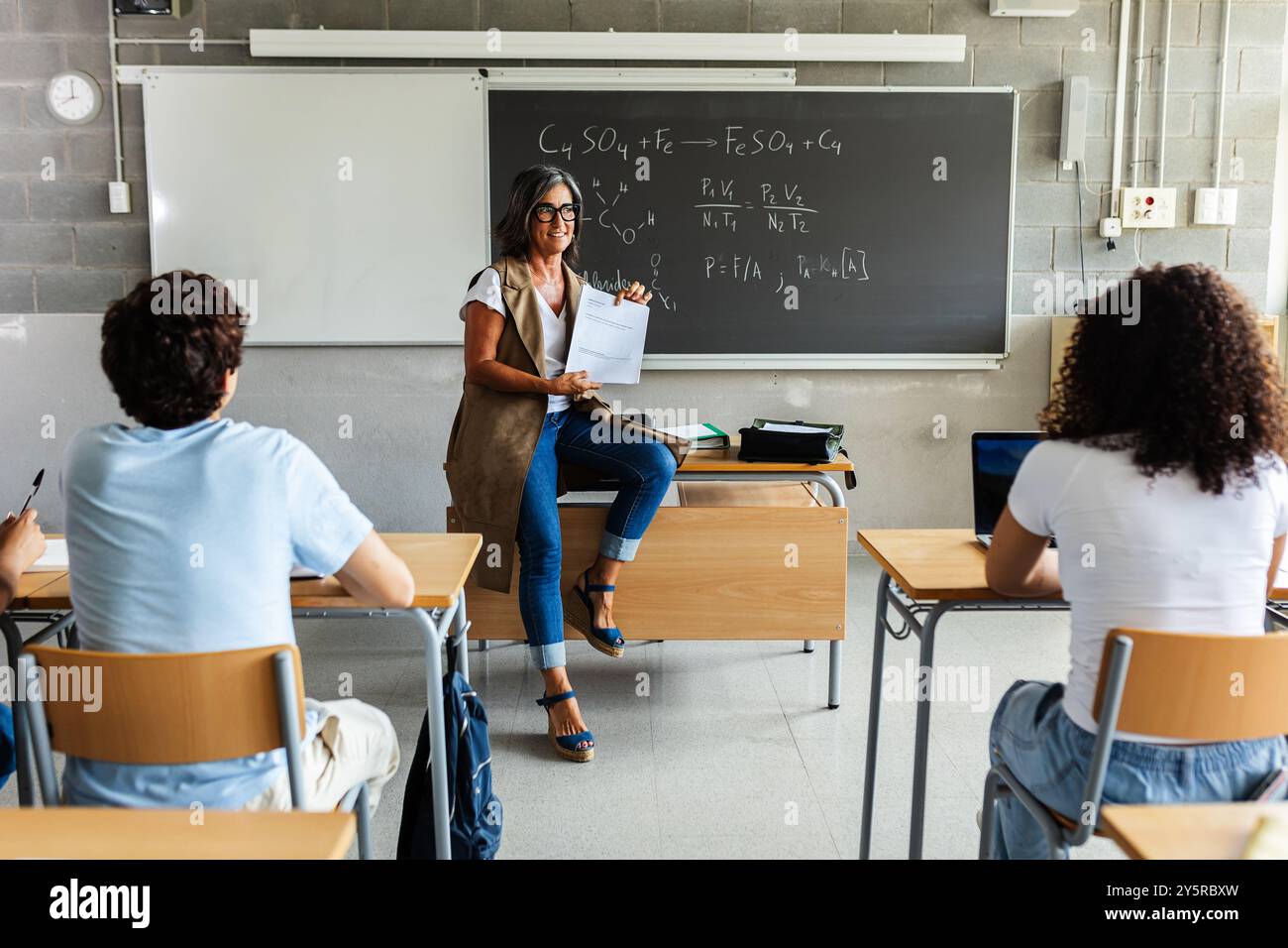Young group of gen z students attending teacher in class at high school ...