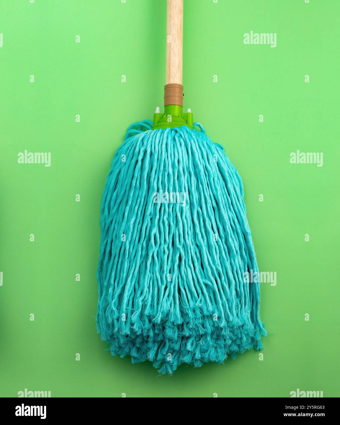 Blue microfiber mop with wooden handle - Green background Stock Photo ...