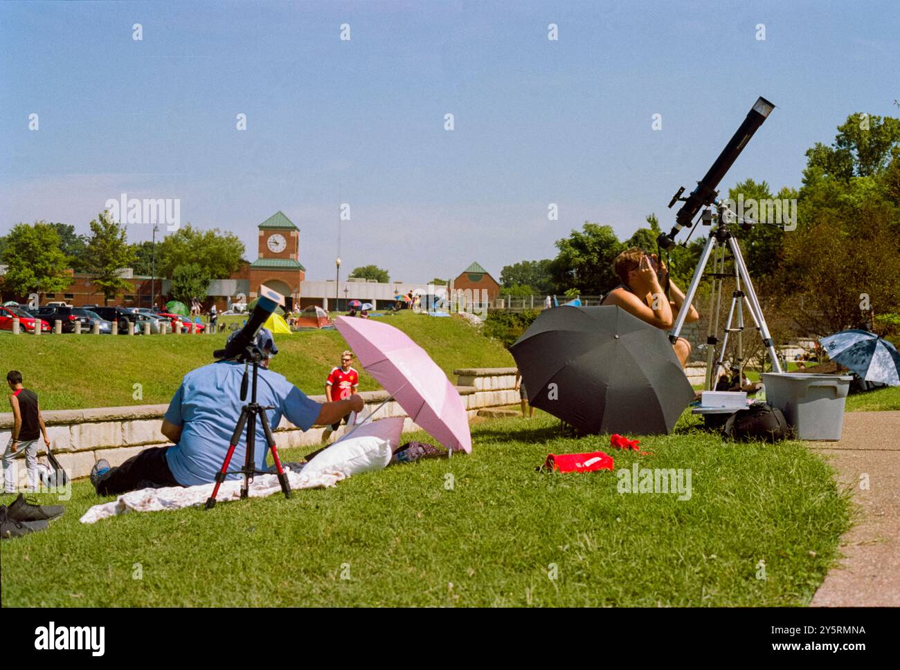 Enthusiasts set up telescopes and umbrellas in Hopkinsville, Kentucky ...