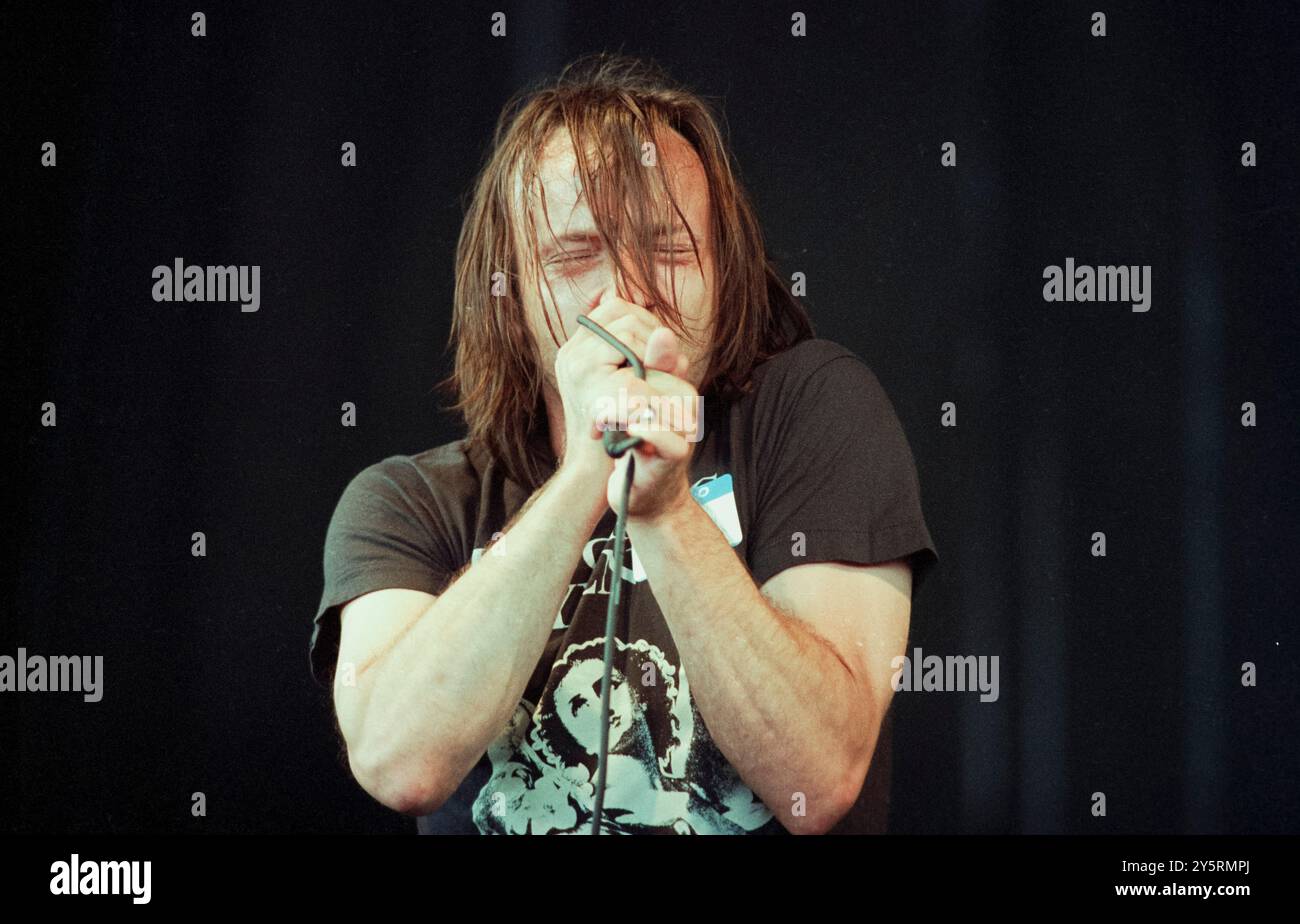 Mid-performance, David Yow of The Jesus Lizard draws in the audience at ...